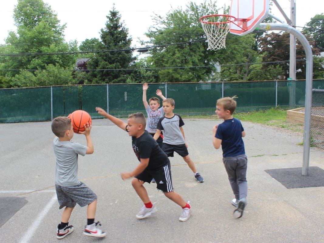 Little Kids Playing Basketball Outside
